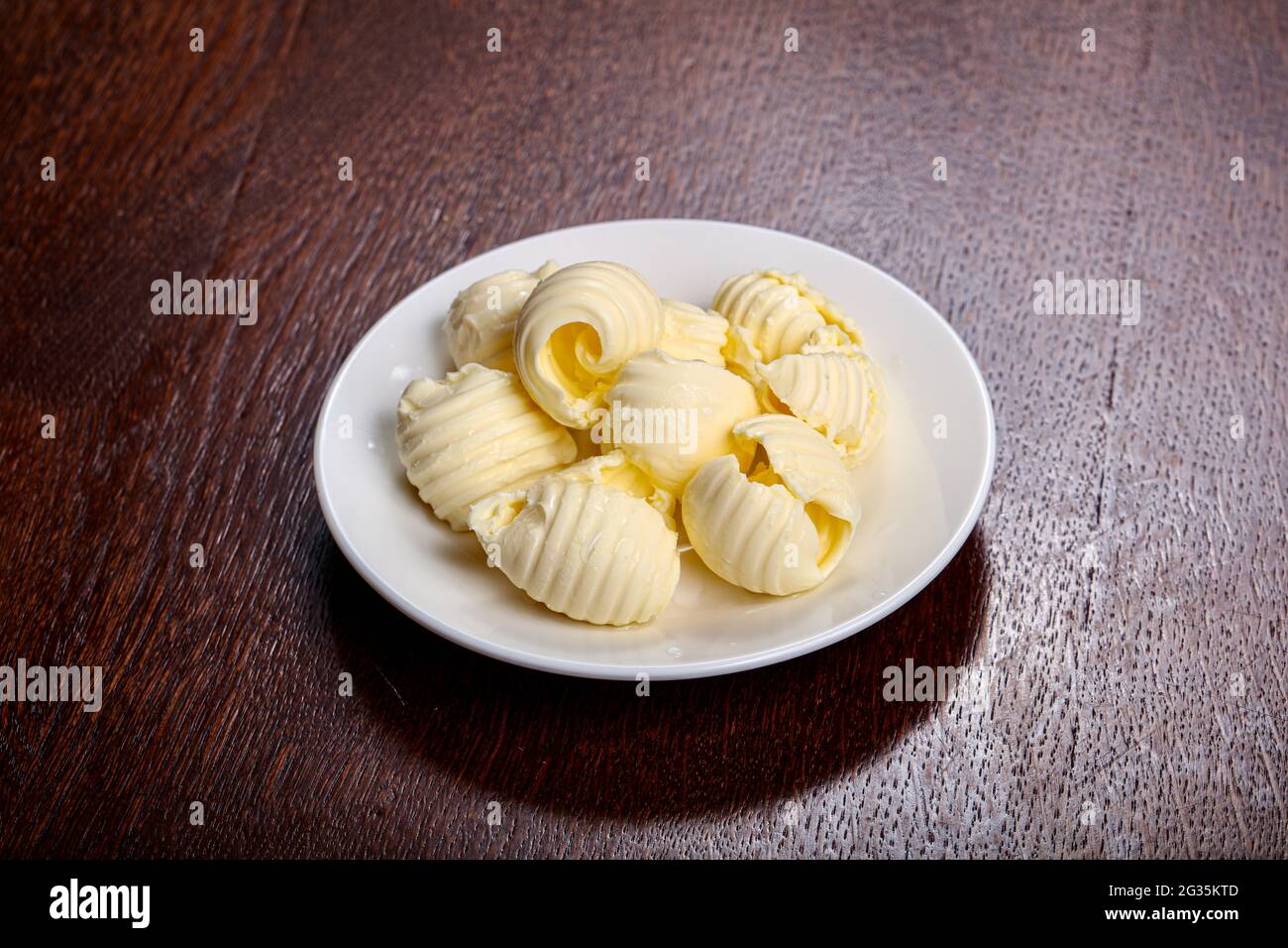 Dairy butter slice for breakfast in the plate Stock Photo - Alamy