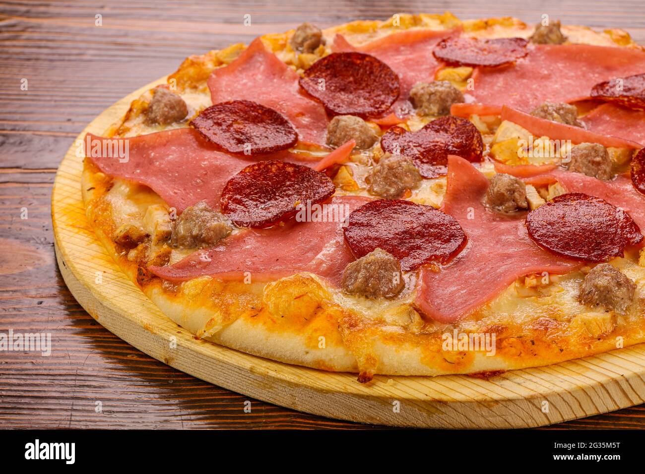 Pizza with ham, cheese and pepperoni Stock Photo - Alamy