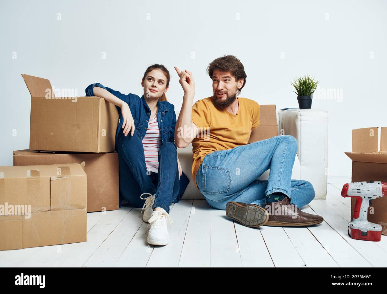 married couple housewarming boxes with things moving Stock Photo - Alamy