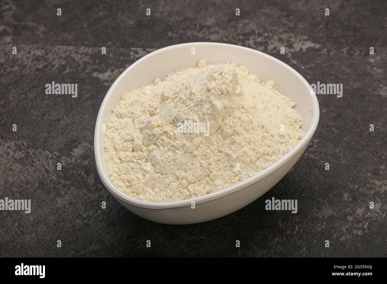 Wheat flour heap in the bowl for cooking Stock Photo - Alamy