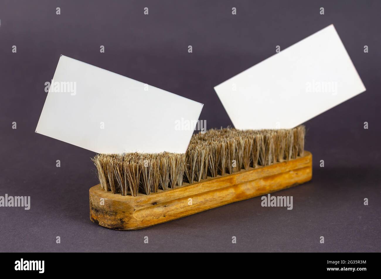 Garment brush and blank business card on gray background. White ...