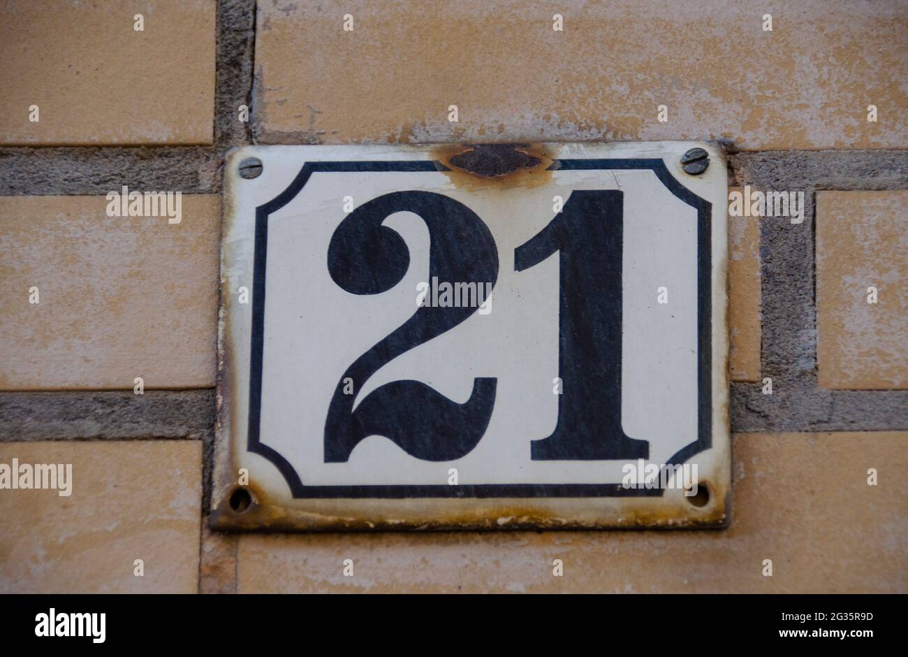 A sign on a wall with the number Stock Photo - Alamy