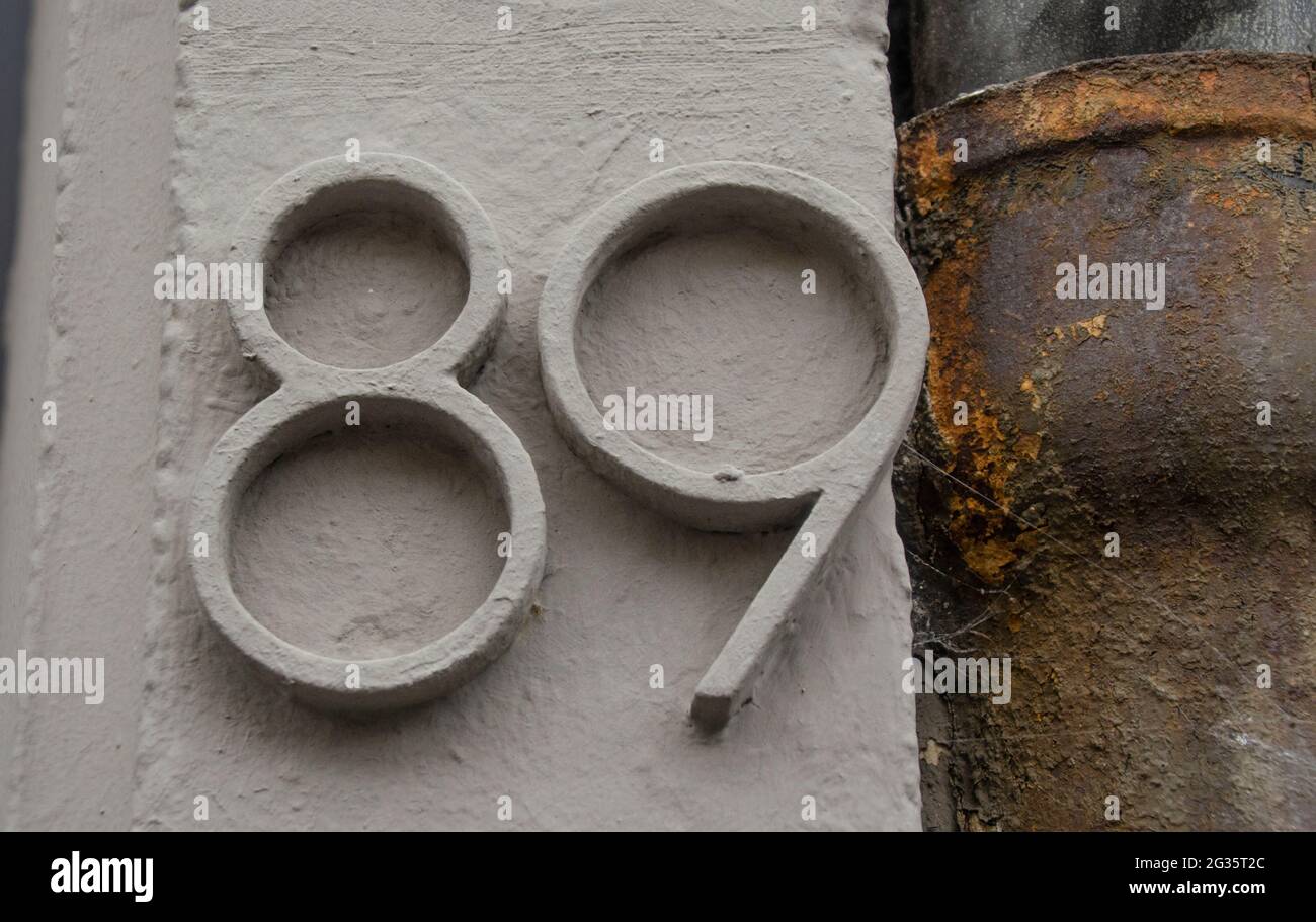 A sign on a wall with the number Stock Photo - Alamy