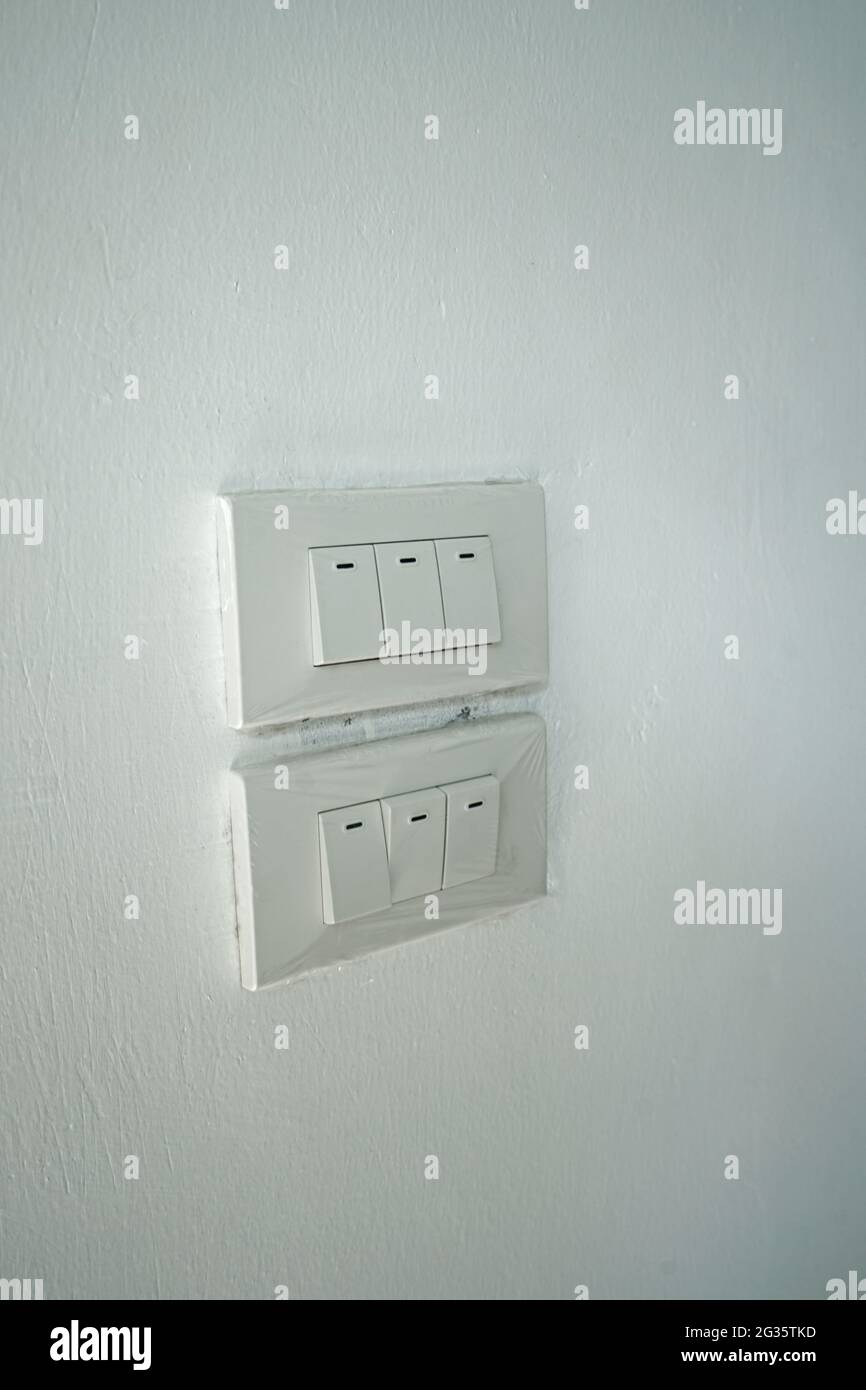 Close up indoor switch panel on white wall Stock Photo - Alamy