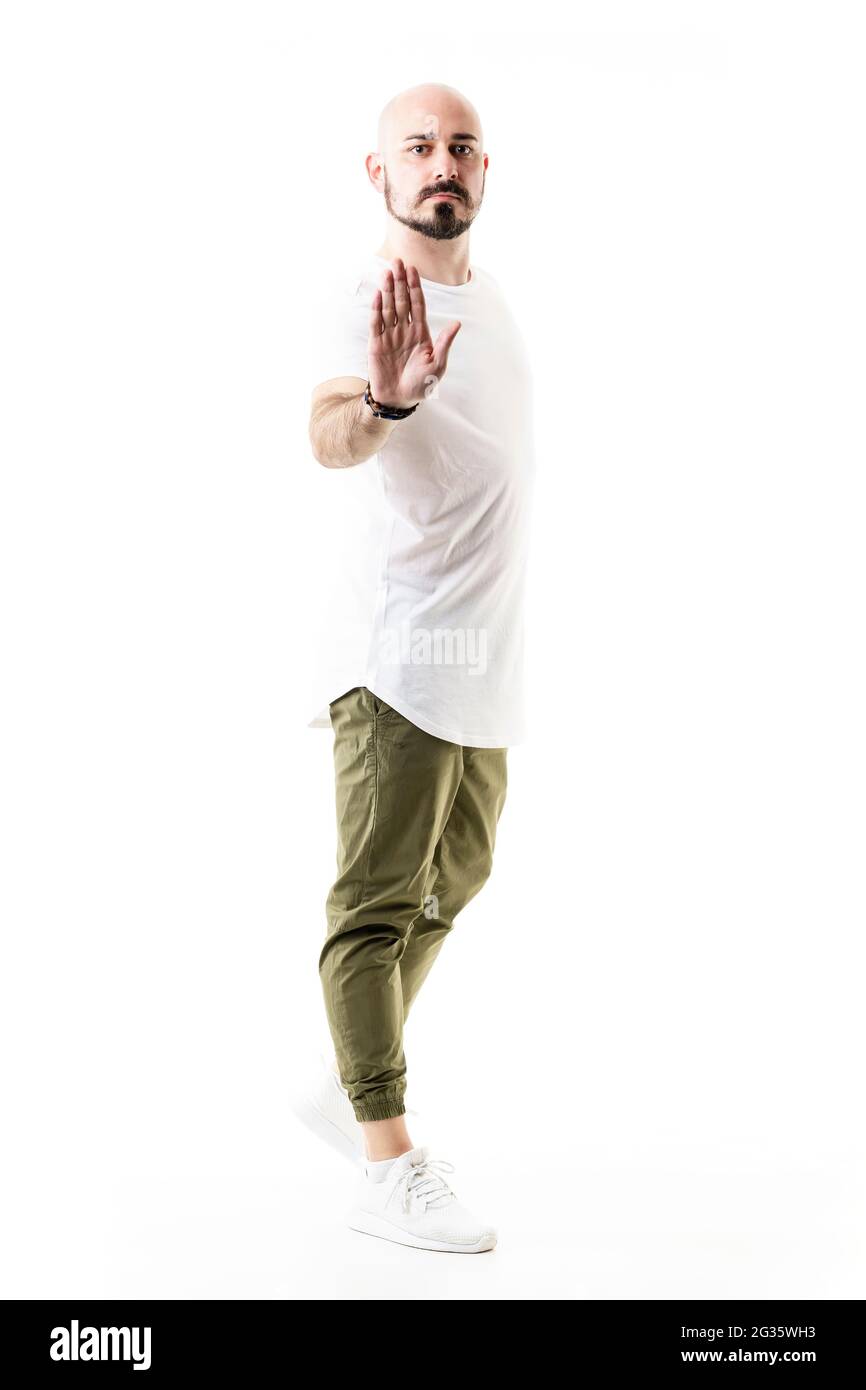 Cool stylish young man showing stop hand gesture at camera. Full body ...