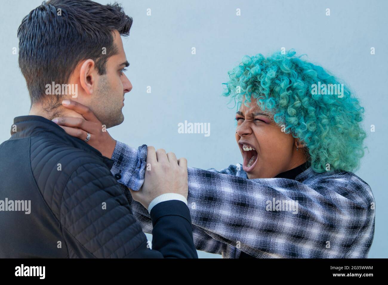 couple fighting holding each other in the street Stock Photo - Alamy