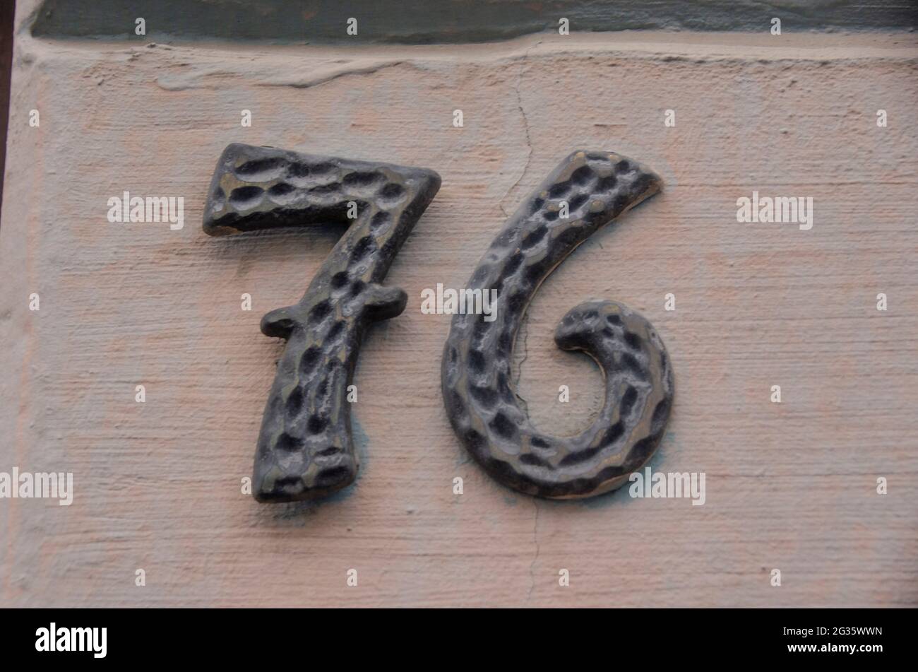 A sign on a wall with the number Stock Photo - Alamy