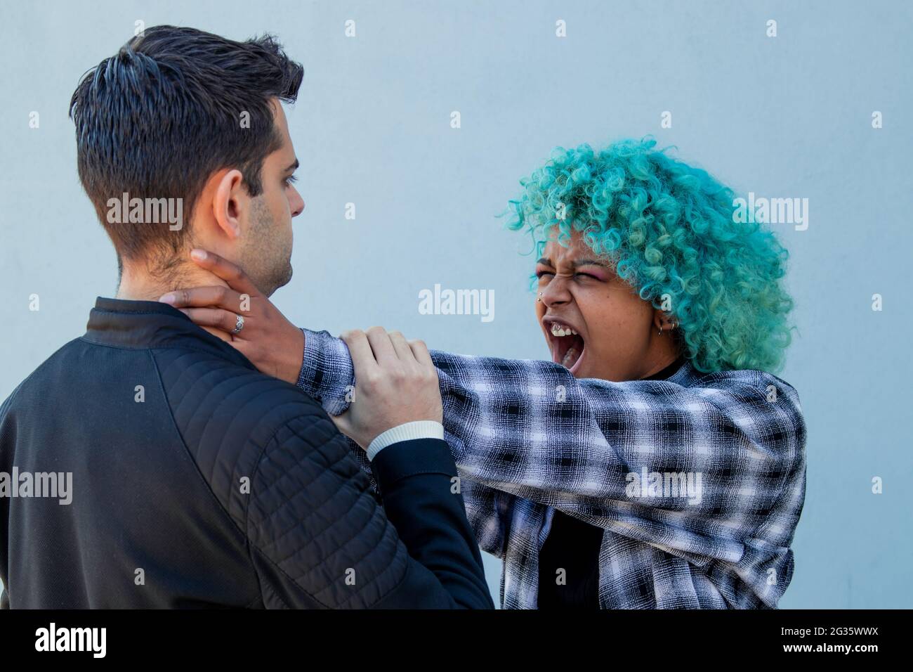 couple fighting holding each other in the street Stock Photo - Alamy