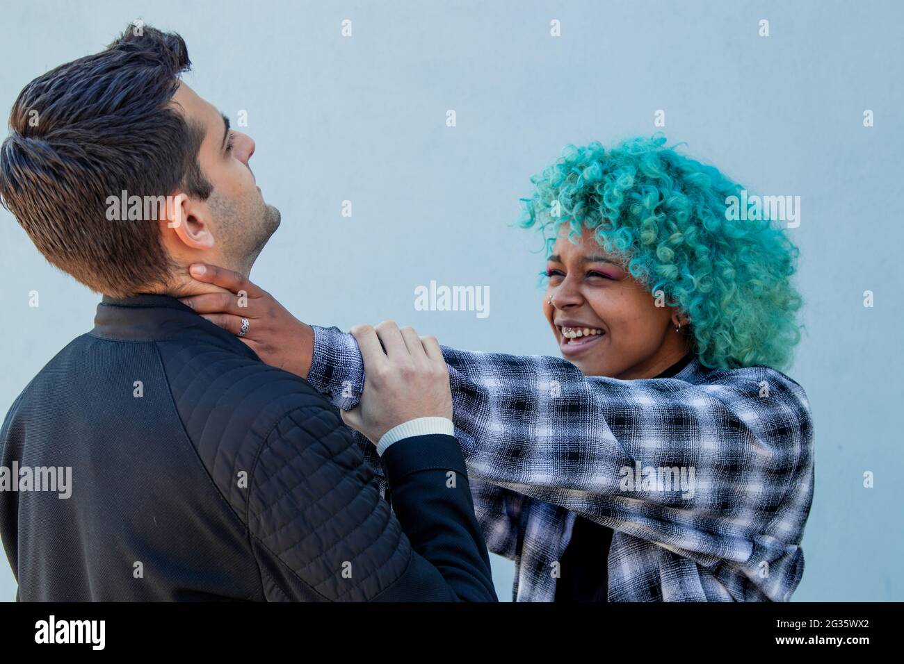 couple fighting holding each other in the street Stock Photo - Alamy
