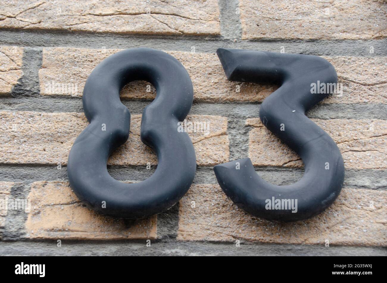 A sign on a wall with the number Stock Photo - Alamy