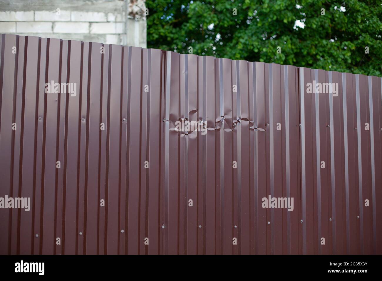 Crumpled metal fence. Damaged fence. Dents on the metal Stock Photo - Alamy