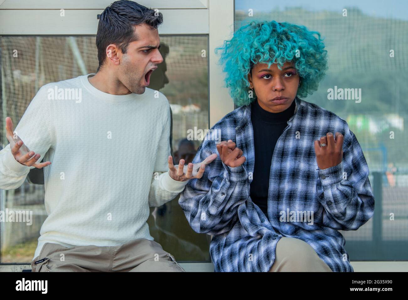 couple with boy yelling at girl who loses patience Stock Photo - Alamy