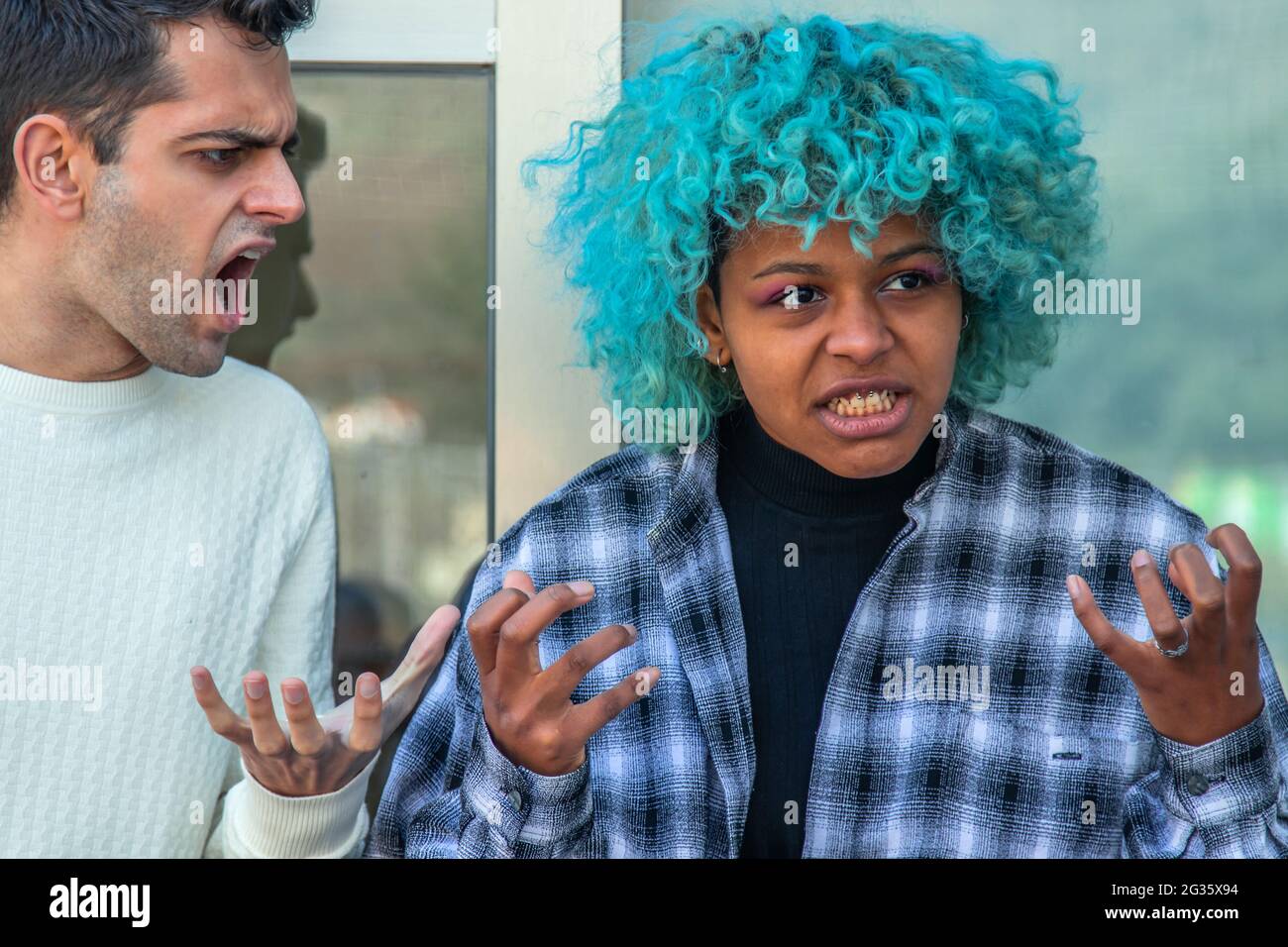 couple with boy yelling at girl who loses patience Stock Photo - Alamy
