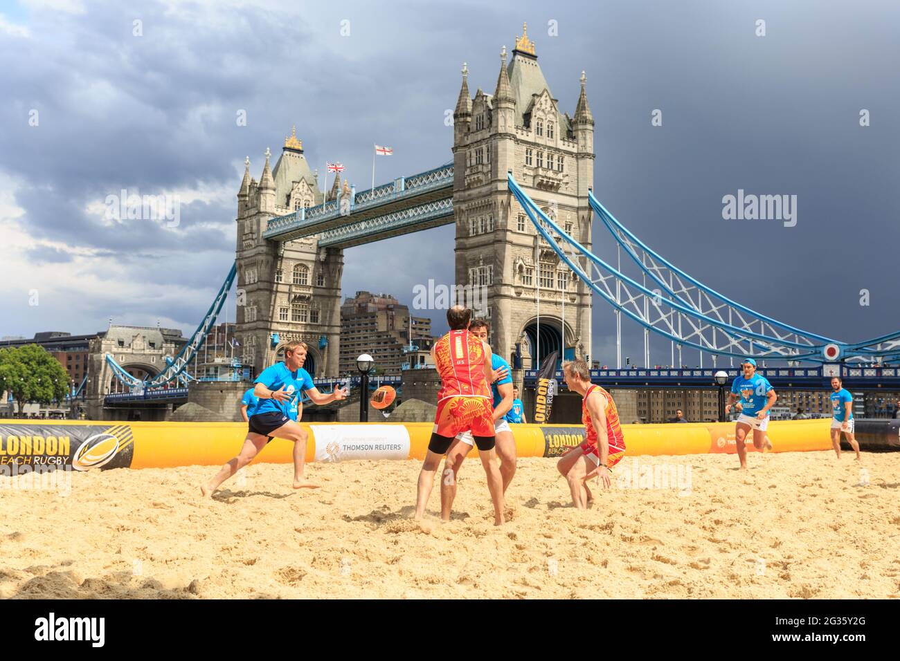 Rugby players in game at London Beach Rugby event near Tower Bridge ...