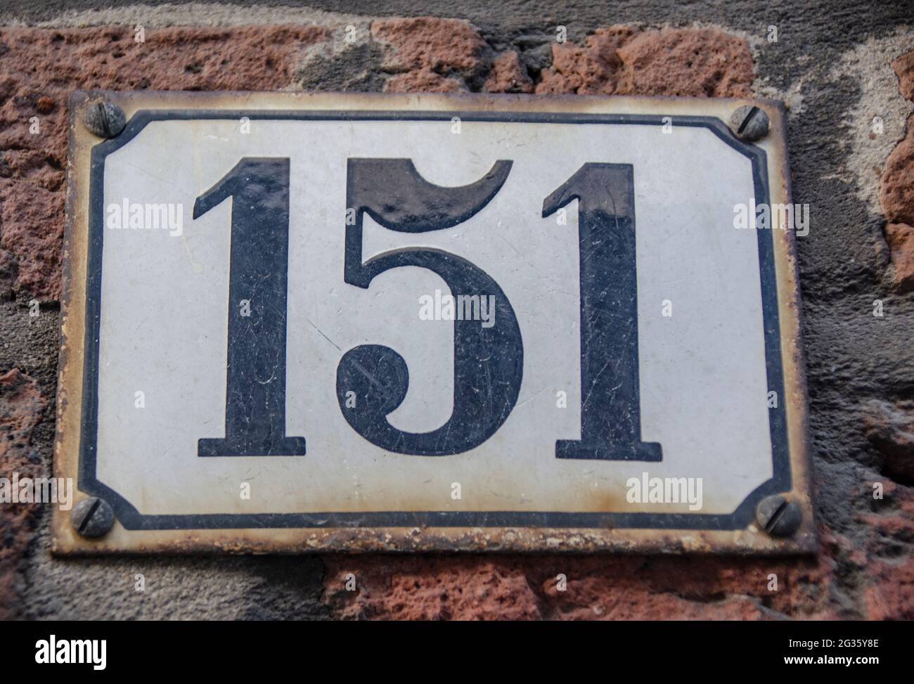 A sign on a wall with the number Stock Photo - Alamy