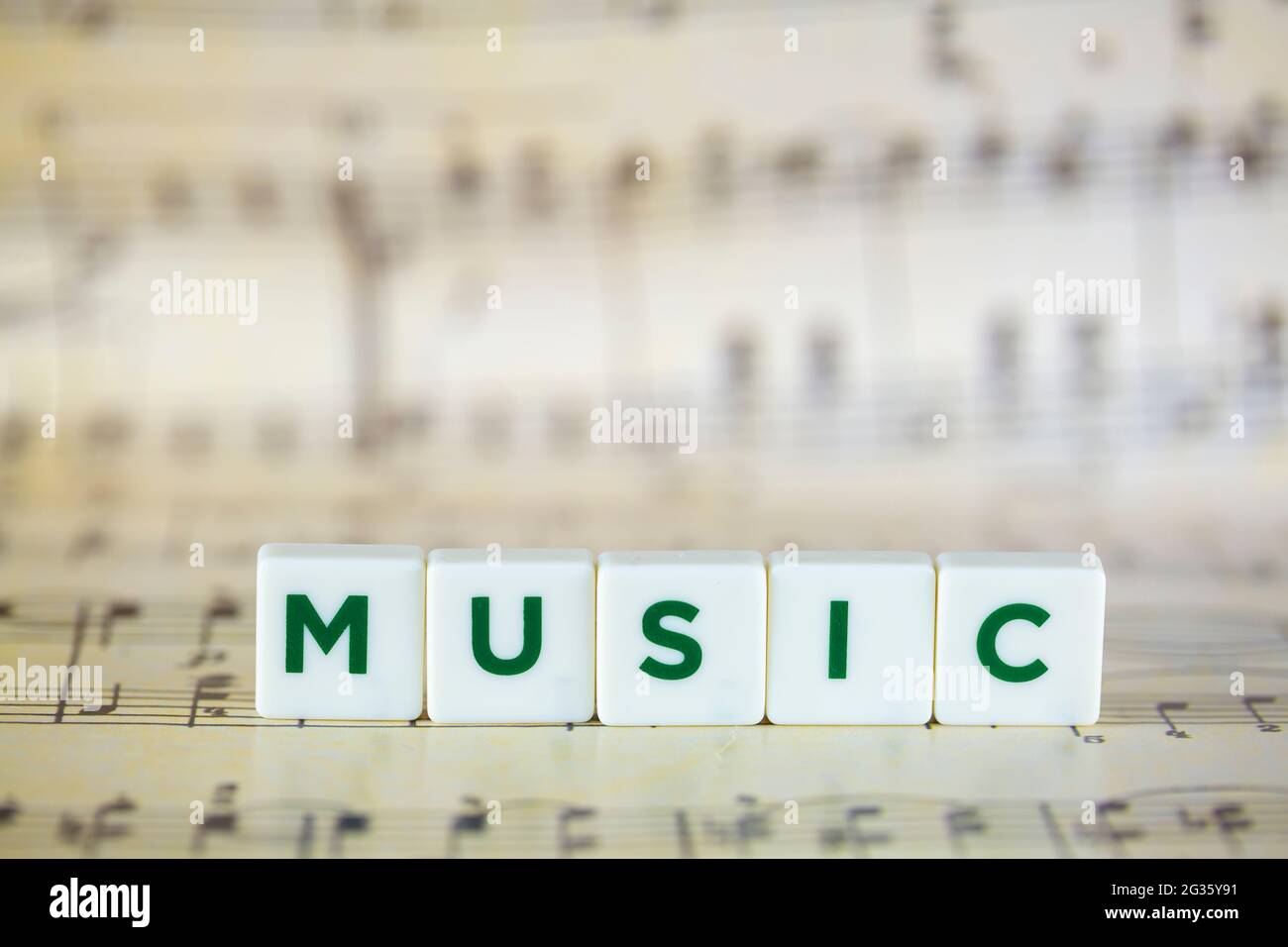 Old musical notes and letter cubes Stock Photo - Alamy