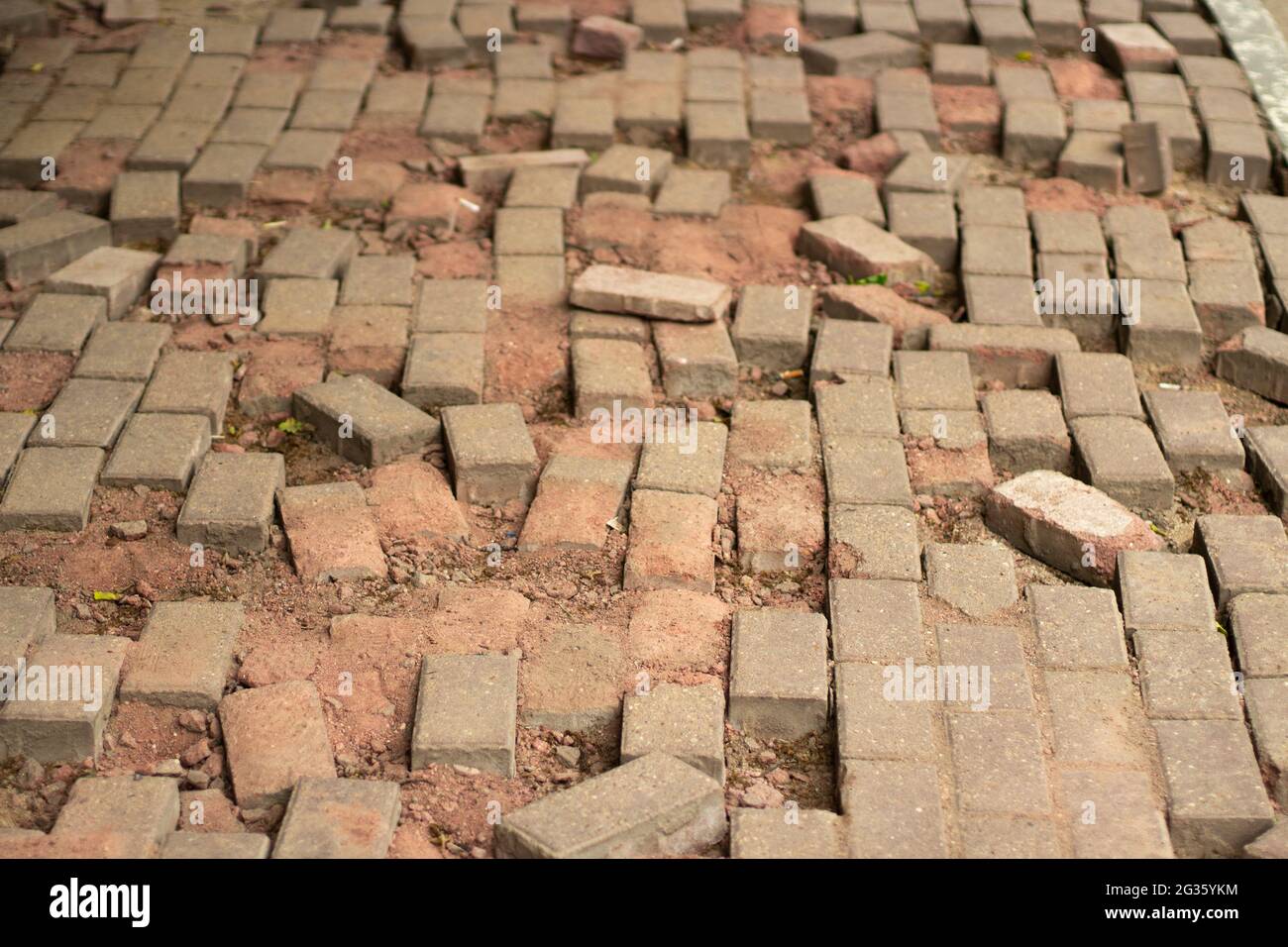 Broken paving stones on the road. The masonry is broken. The pedestrian ...