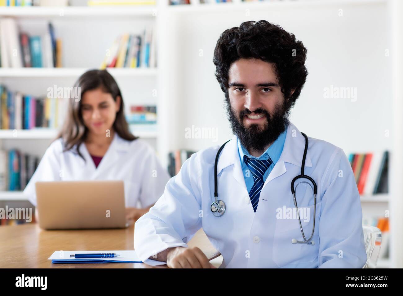 Laughing arabic male doctor with nurse at hospital Stock Photo - Alamy
