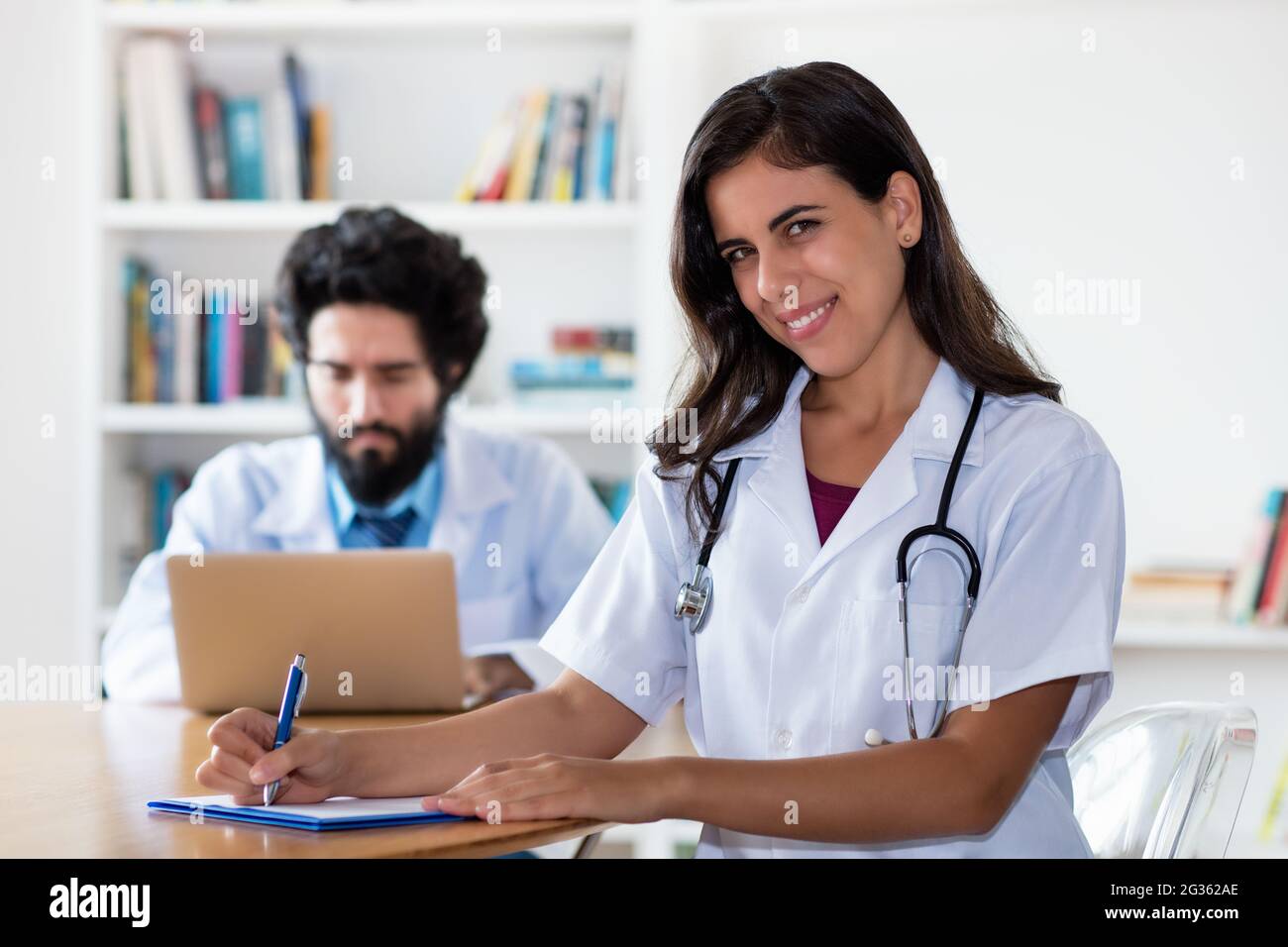 Laughing latin medical female student with doctor at hospital Stock ...