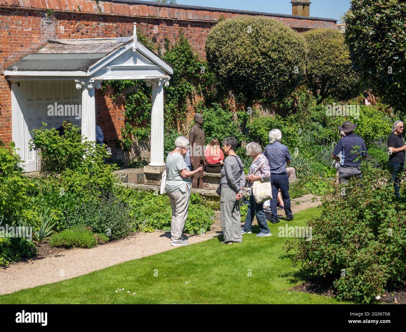 Visitors to the Walled Garden at the stately home of Nevill Holt Hall ...