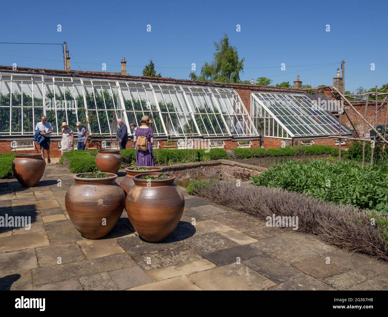 Visitors to the Walled Garden at the stately home of Nevill Holt Hall ...