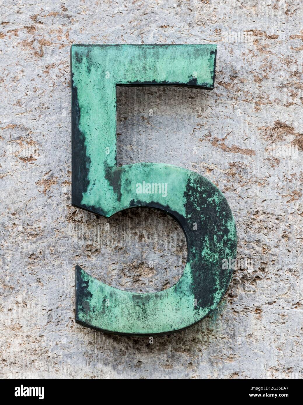 Number 5 covered with verdigris mounted on a natural stone wall Stock ...