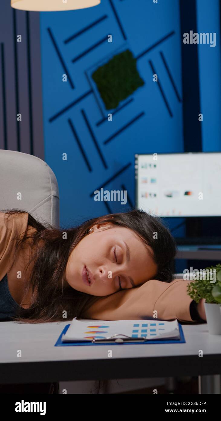 Businesswoman sleeping on desk while working at accounting statistics ...