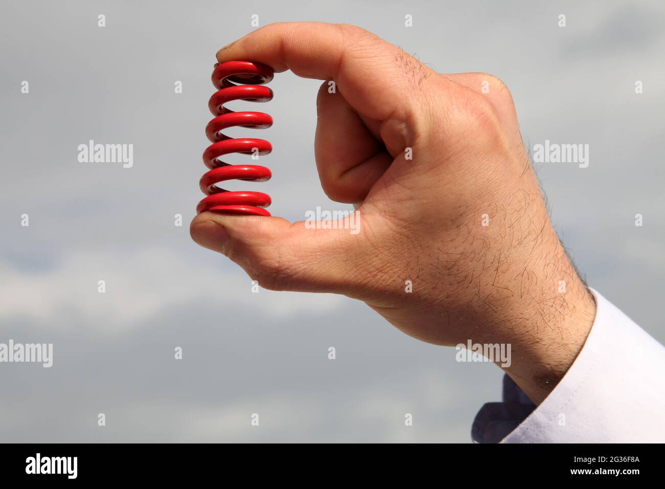 Metal spring in the hands of the engineer. Newly manufactured metal ...