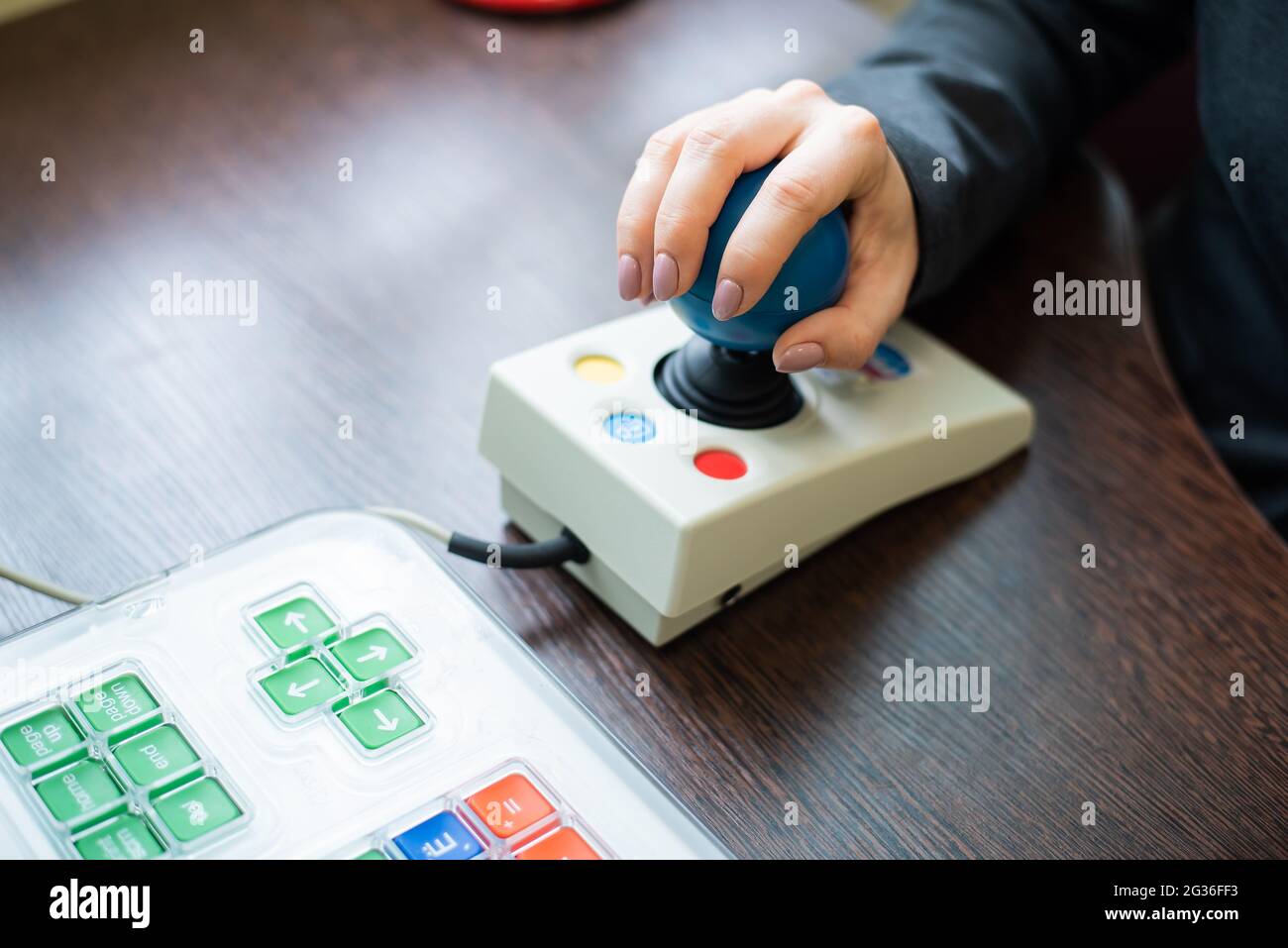 Woman with cerebral palsy works on a specialized computer mouse Stock ...
