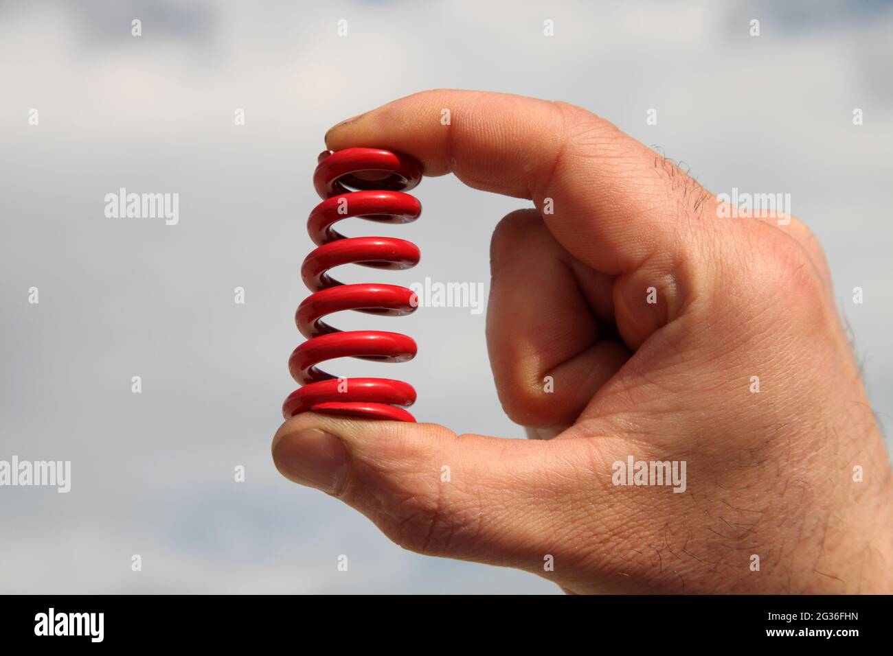 Metal spring in the hands of the engineer. Newly manufactured metal ...