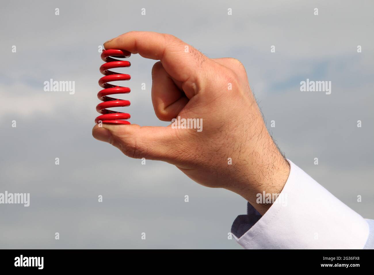 Metal spring in the hands of the engineer. Newly manufactured metal ...