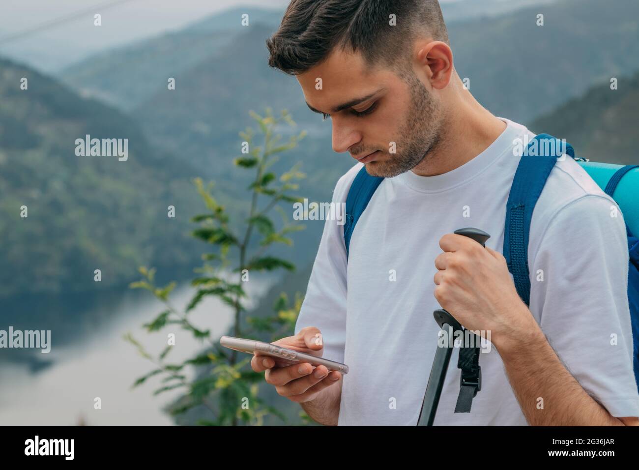traveler man with mobile phone in nature Stock Photo - Alamy