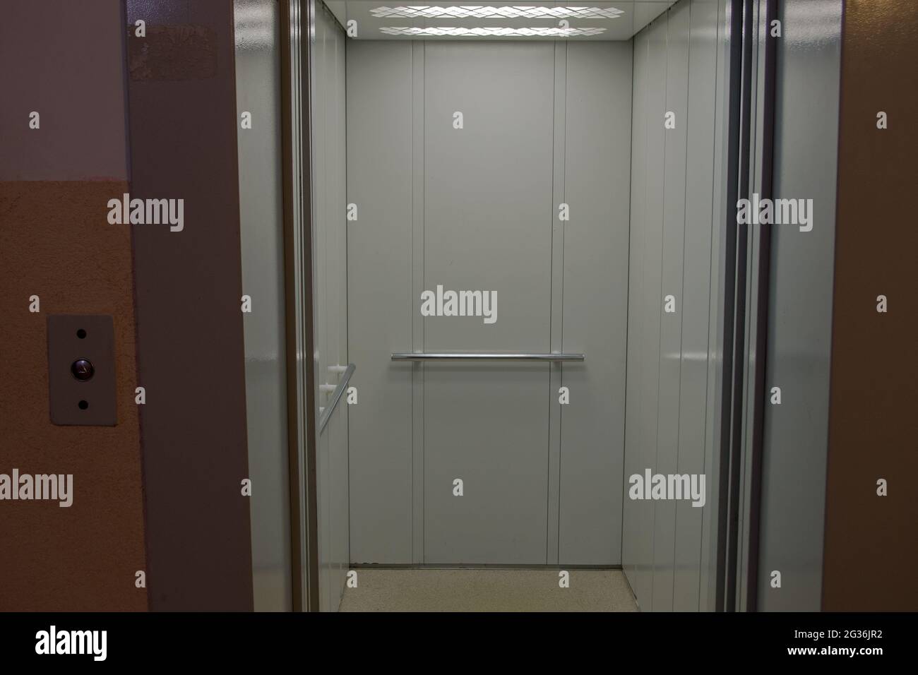 The Elevator and its interior painted light gray with metal handrails ...