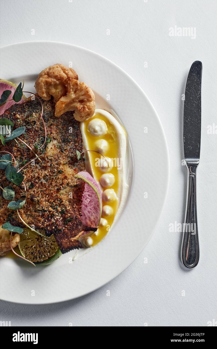 Grilled cabbala fish. on a light background, banquet serving of a dish ...