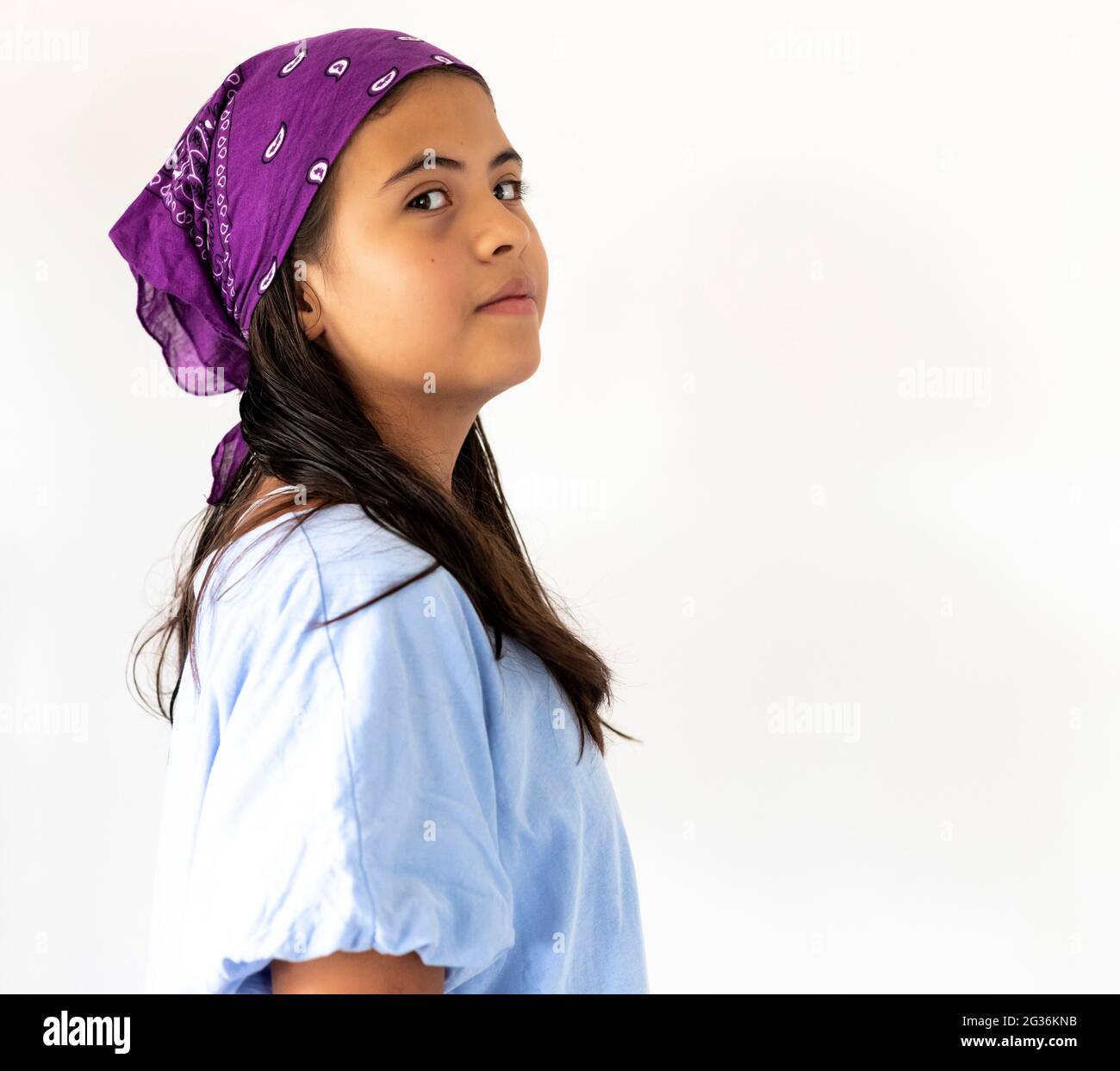 pre teenage girl with purple scarf standing and looking at camera Stock ...