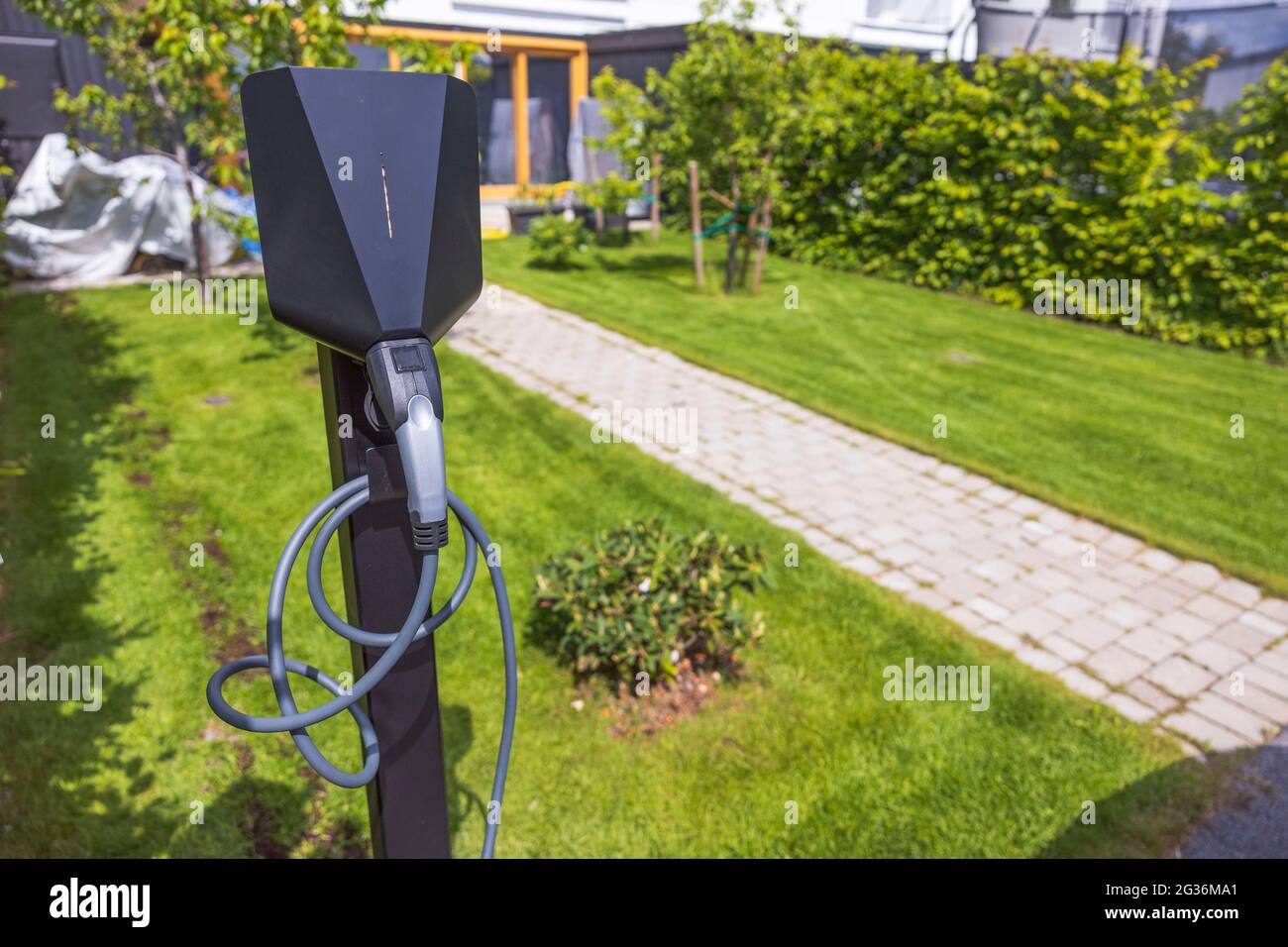 Close up view of charging station for electric car in front yard of ...