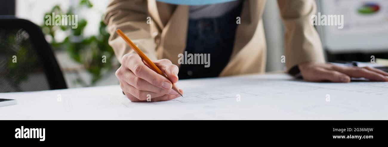 partial view of engineer drawing blueprint in office, banner Stock ...