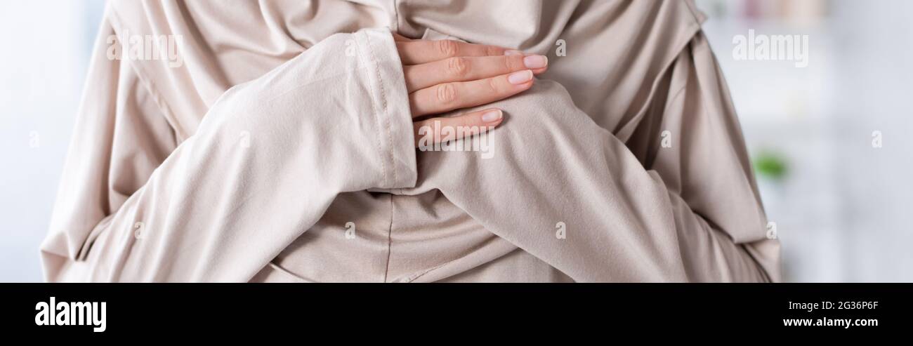 cropped view of muslim woman praying with hands on chest, banner Stock ...