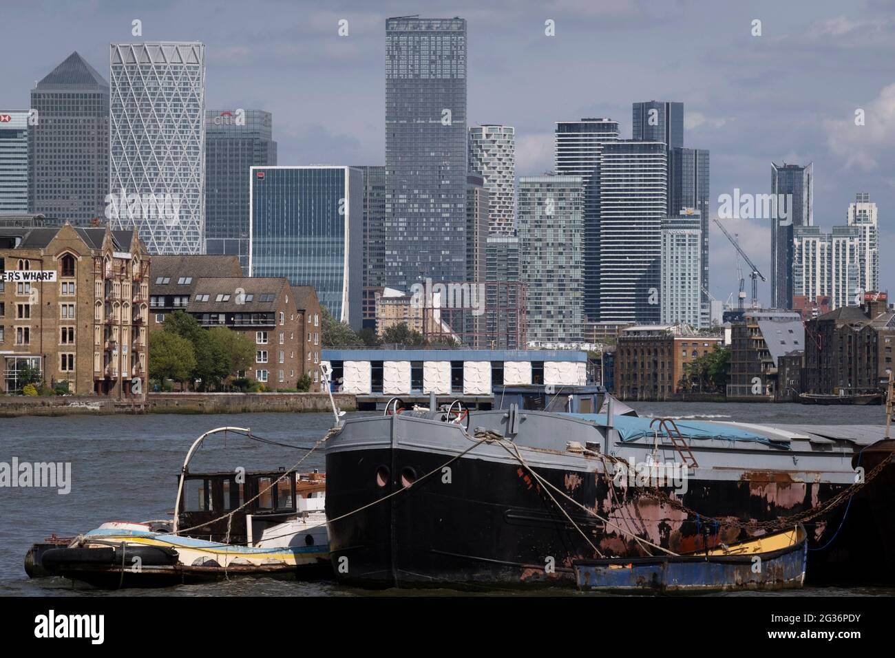 With London Docklands delvelopment in the distance, boats at Tower ...