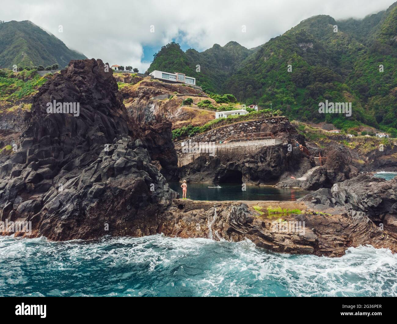 Cliffs and forested mountains on the coast of a sea Stock Photo - Alamy