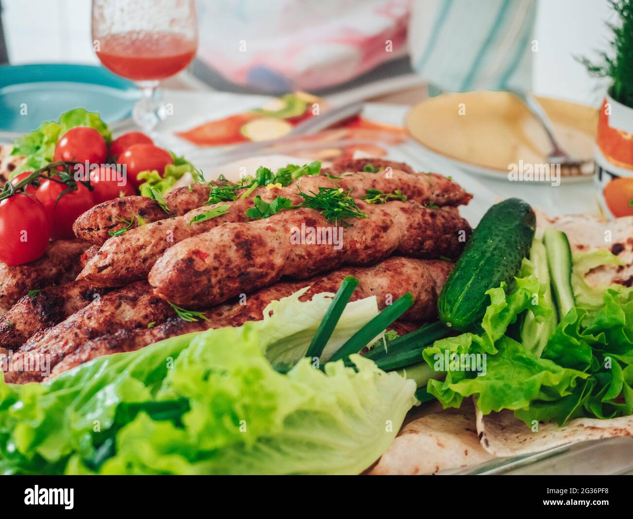 Plate of grilled kebab with green onion and fresh vegetables Stock ...