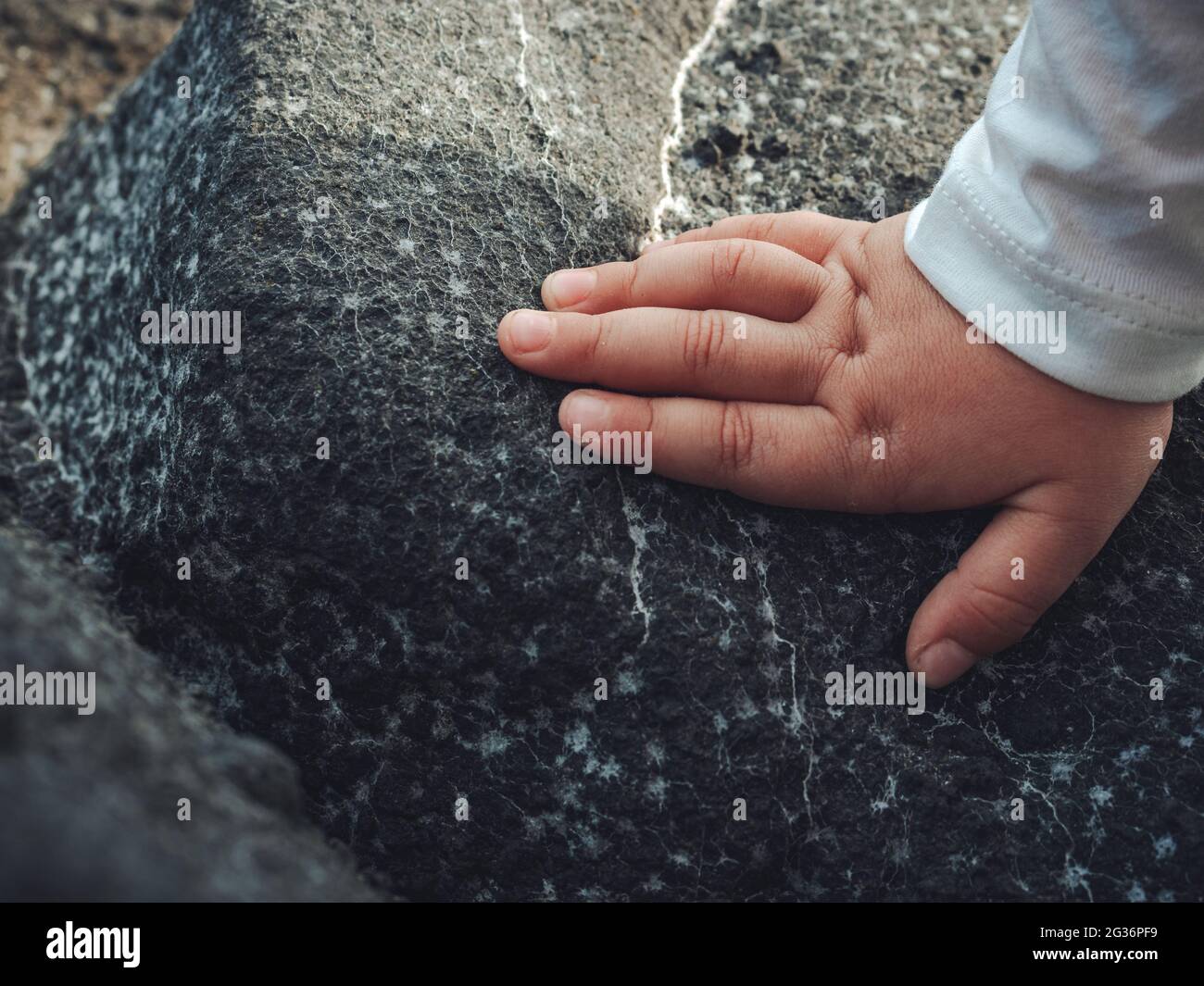 Hand of a child on a stone surface Stock Photo - Alamy