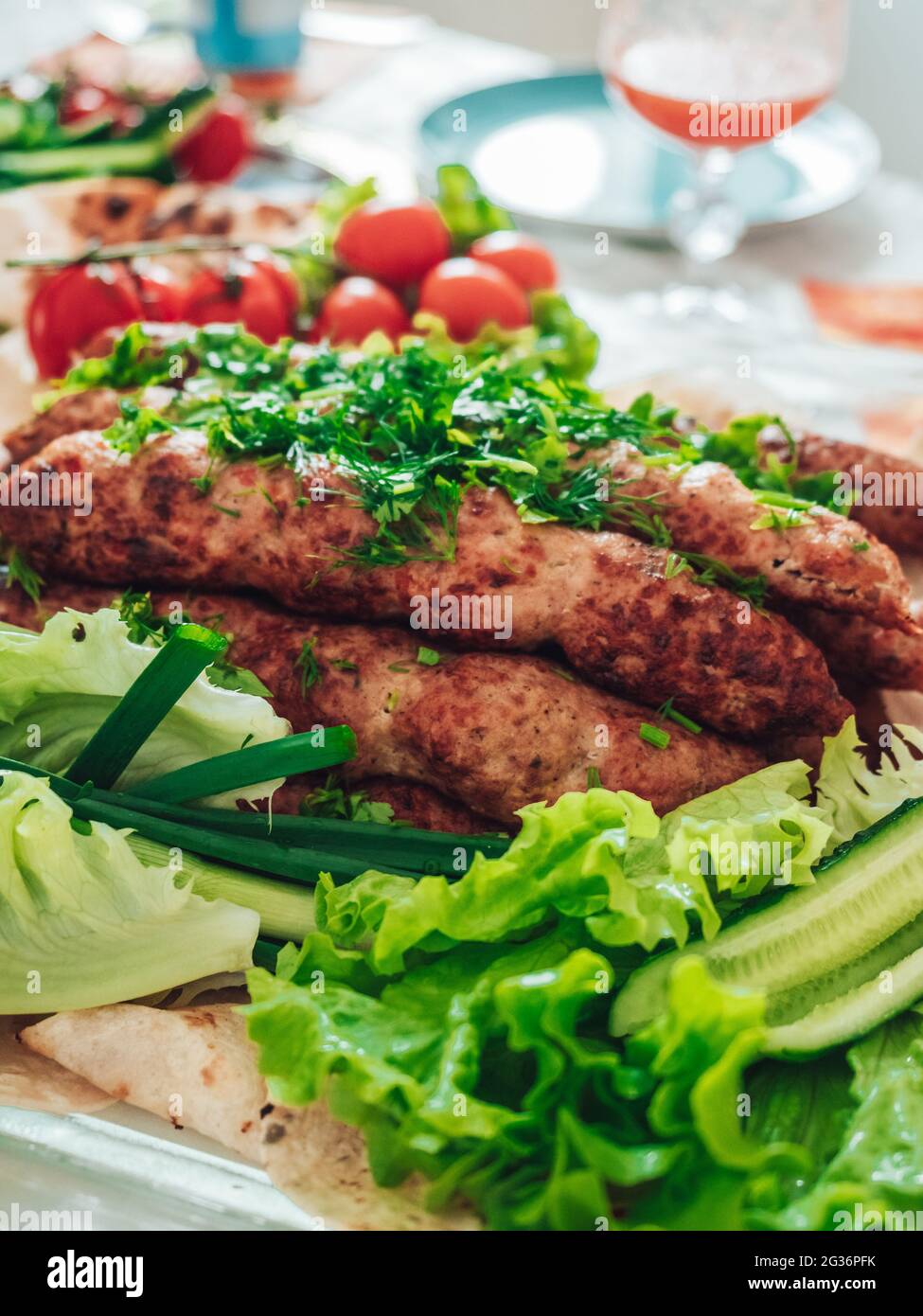 Plate of grilled kebab with green onion and fresh vegetables Stock ...