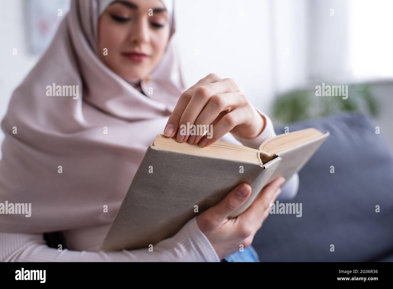 blurred muslim woman reading novel at home Stock Photo - Alamy
