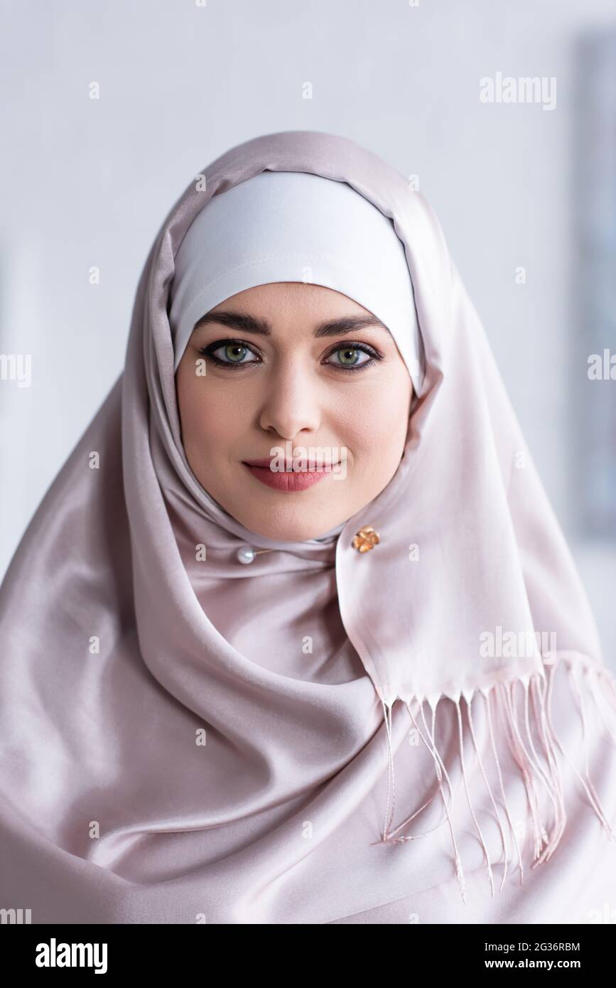portrait of pretty muslim woman smiling while looking at camera Stock ...