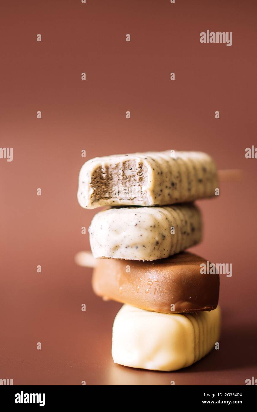 Different chocolate Popsicles lying on top of each other. brown ...