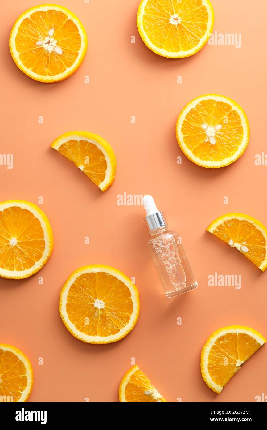 Vitamin c serum dropper bottle with sliced orange top view. Natural ...