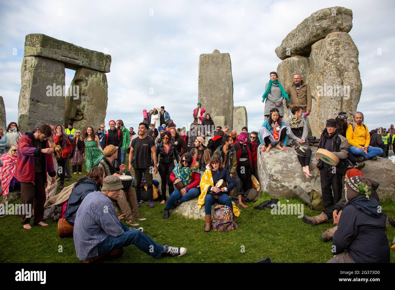 Revellers celebrating the summer solstice amongst the ancient stones of ...