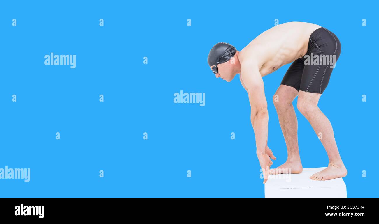 Composition of male swimmer on starting block with copy space isolated ...