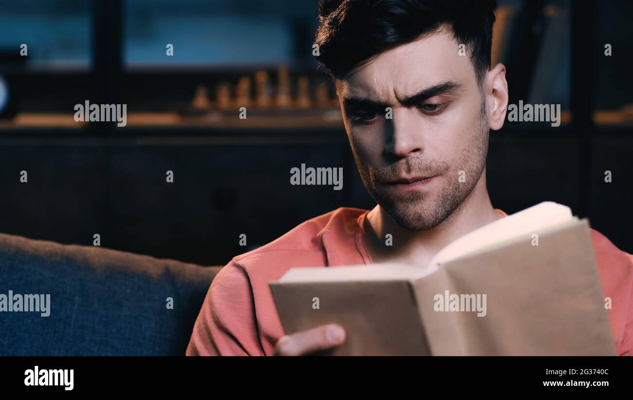 focused man reading book at home Stock Photo - Alamy